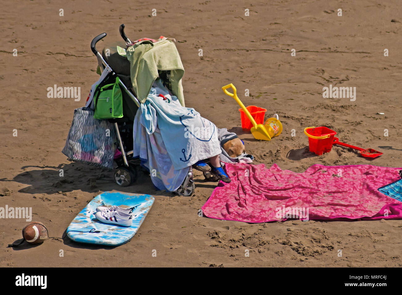 Sun-screened to the Max! Two sunbathers enjoy the summer sun on ...