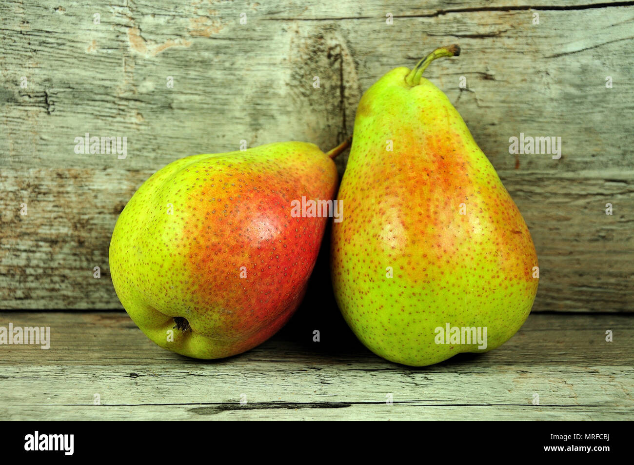 pears with red and yellow skin lying on an old wooden table Stock Photo ...