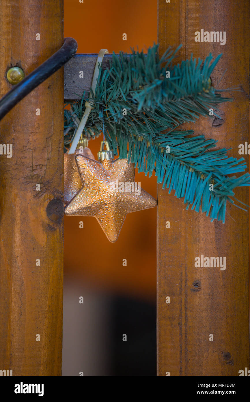 Christmas decoration on a wooden outer fence, a golden star and a ...