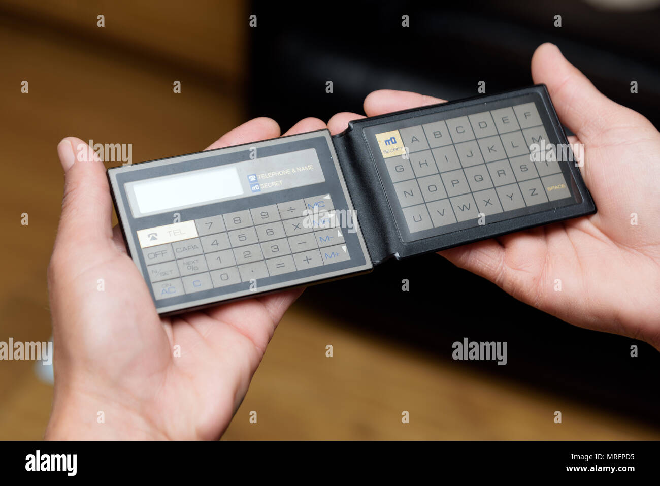 Woman holding a retro old PDA / Calculator Stock Photo - Alamy
