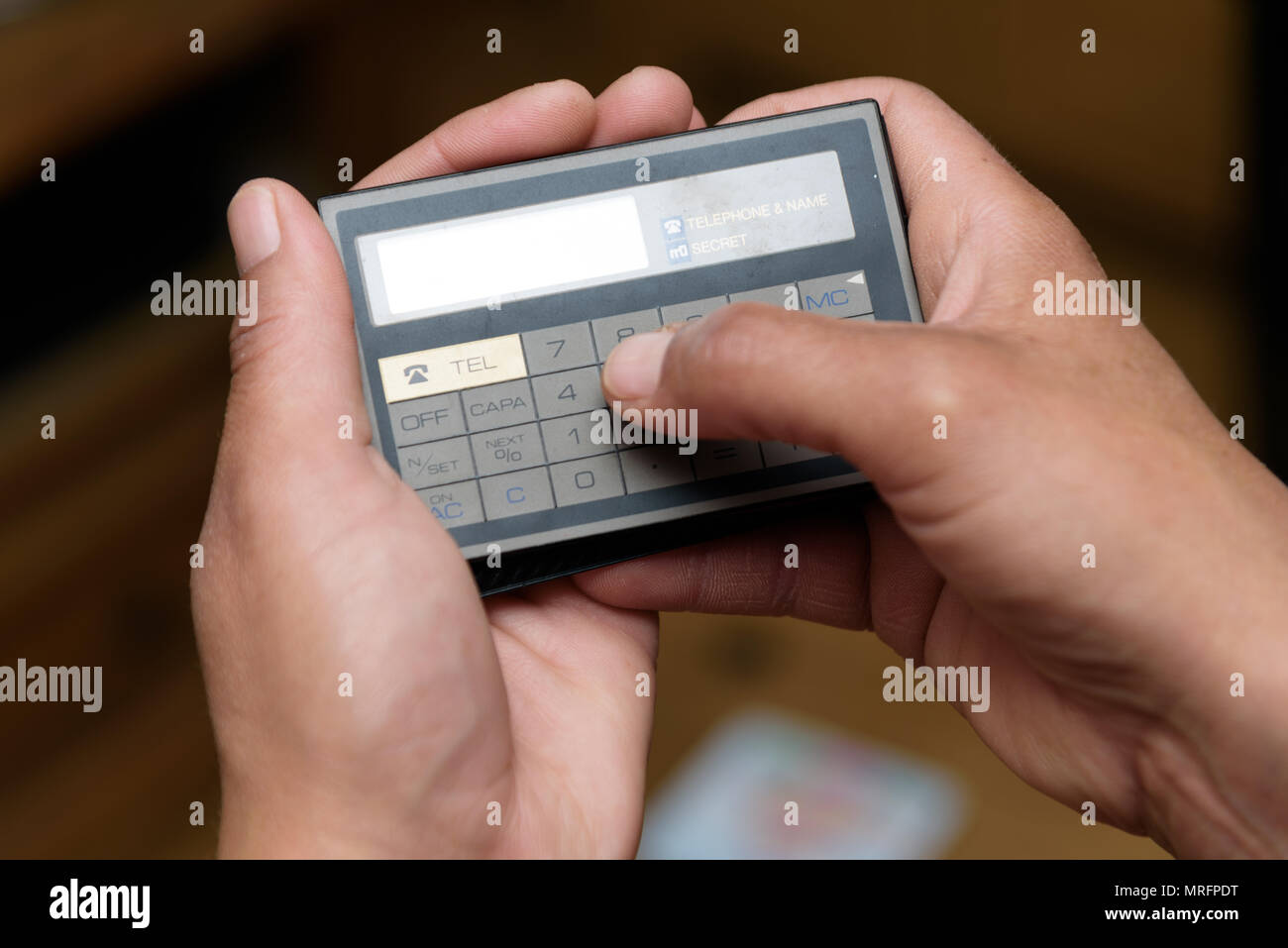 Woman using a retro old PDA / Calculator Stock Photo - Alamy