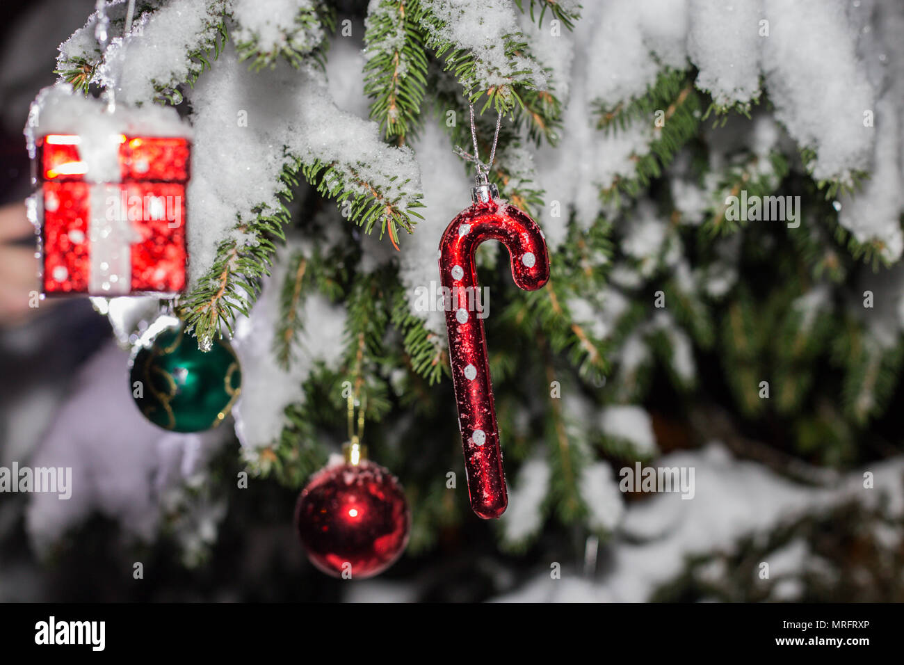 Christmas decorations on a fir tree, with snowflakes, mild light, gifts ...