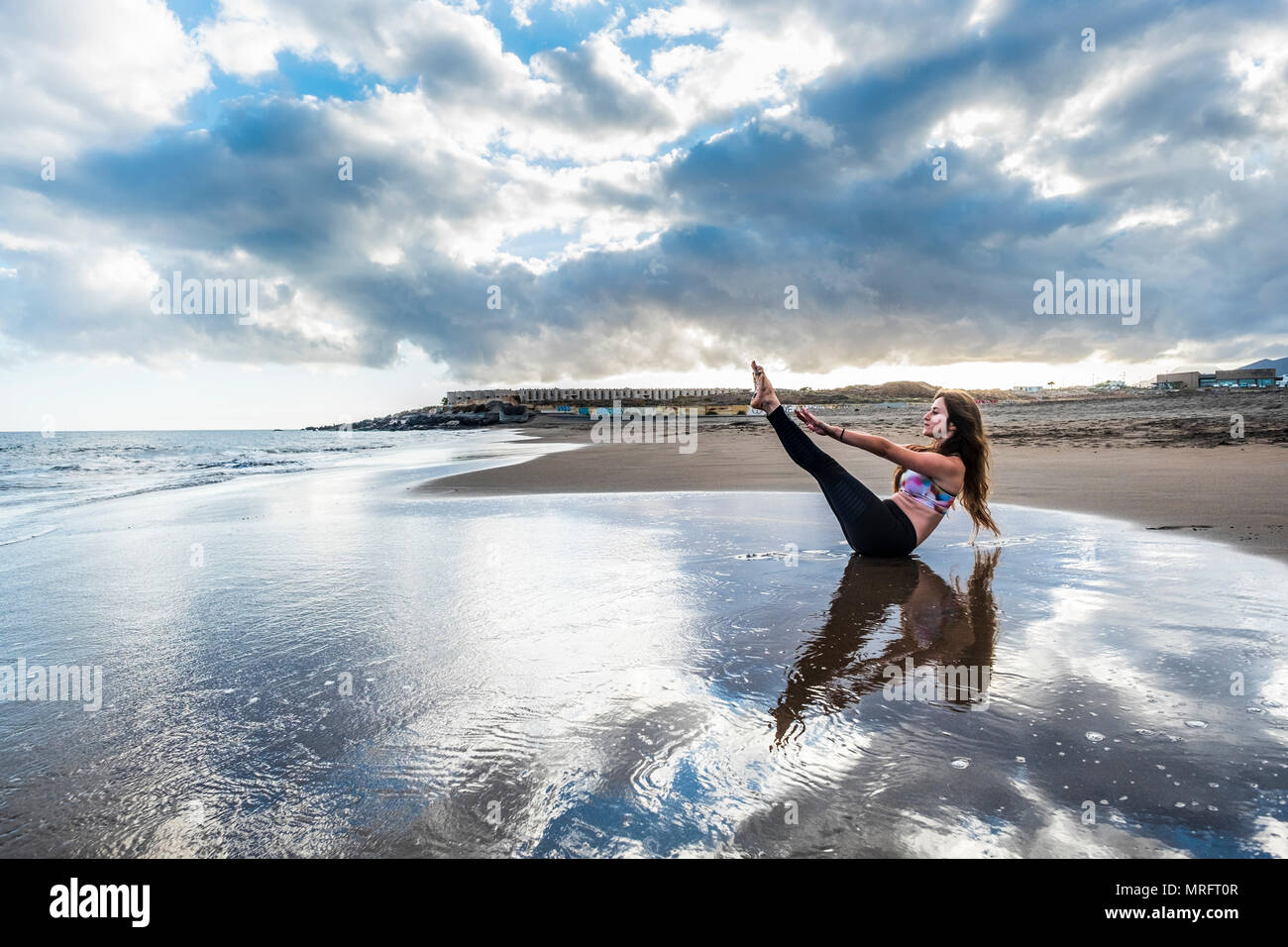 Beach location yoga hi-res stock photography and images - Alamy