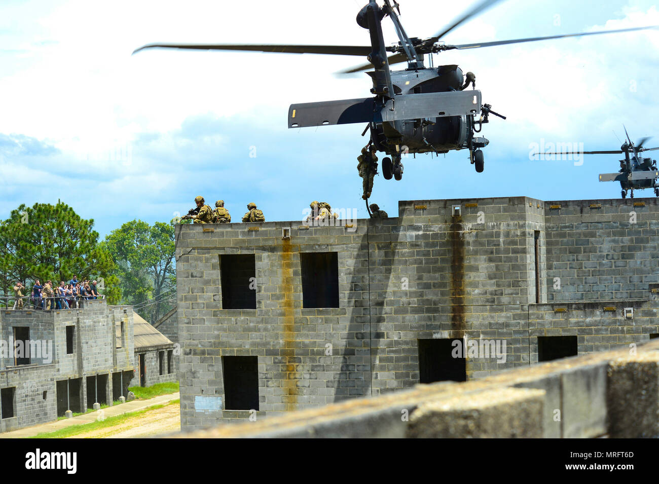 U.S. Army Rangers fast rope onto a building during the capabilities ...