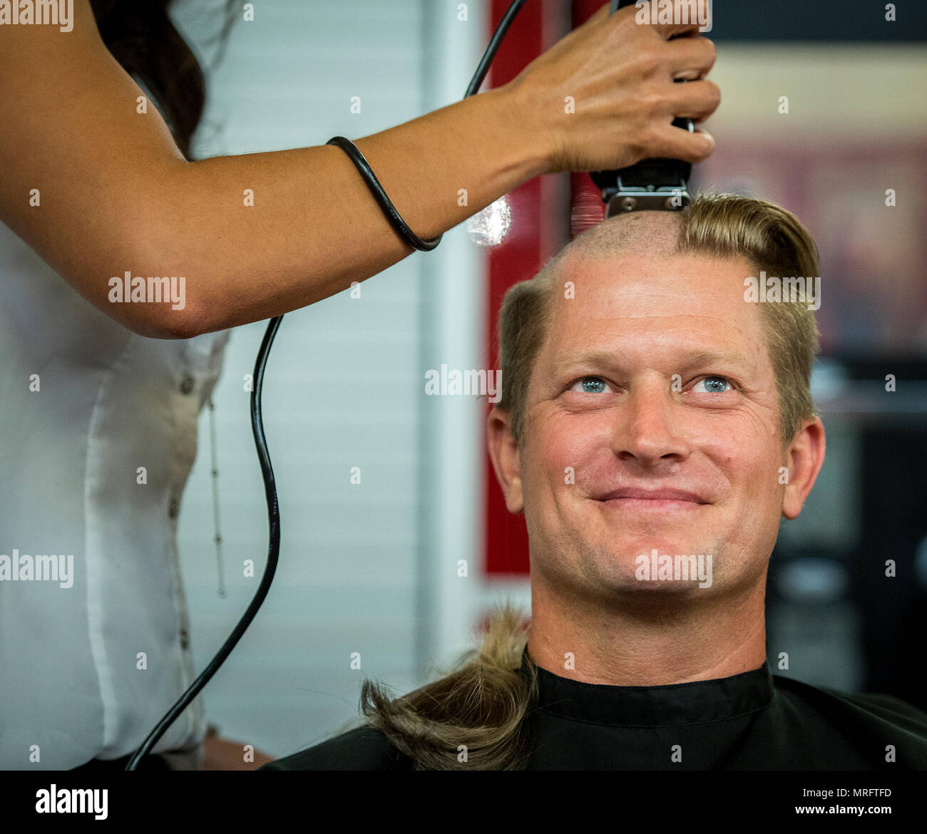 Robert Manby, a 96th Test Wing firefighter, receives a very close shave ...