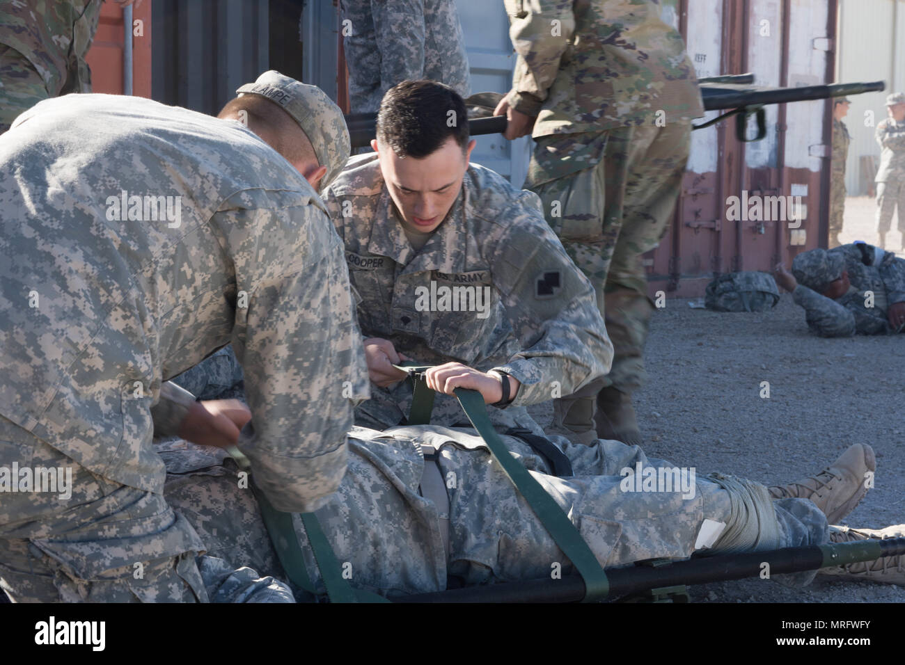 Spc. Jared Cooper, with the 96th Sustainment Brigade, straps a notional ...