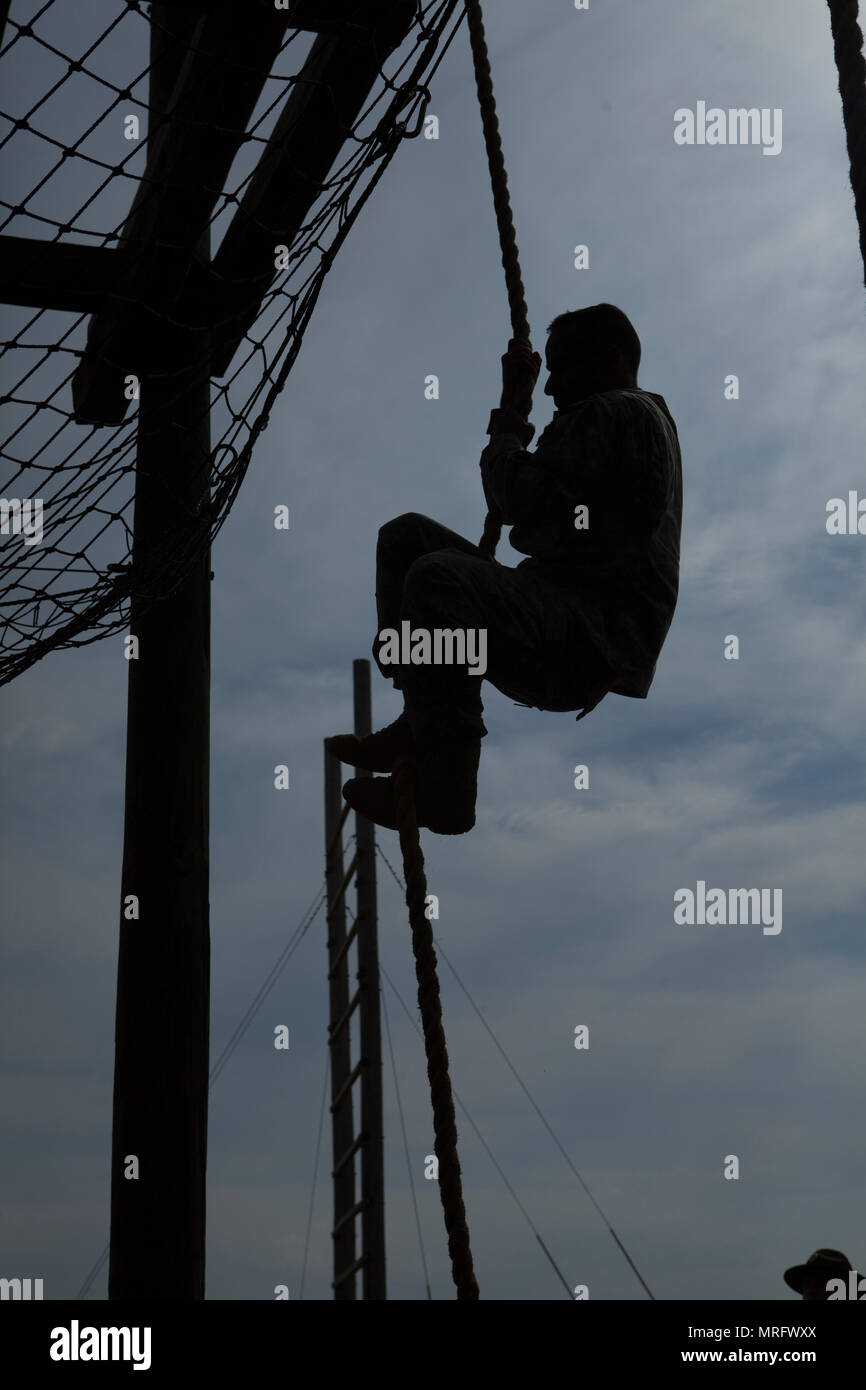 An Army Reserve soldier climbs up a rope obstacle as part of the 2017 U ...