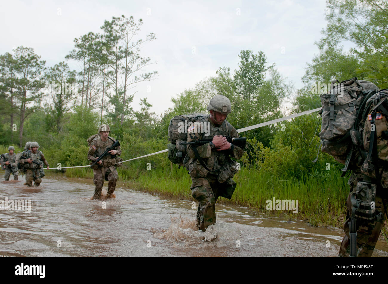 Army Reserve Soldiers cross a water obstacle at the end of an early ...