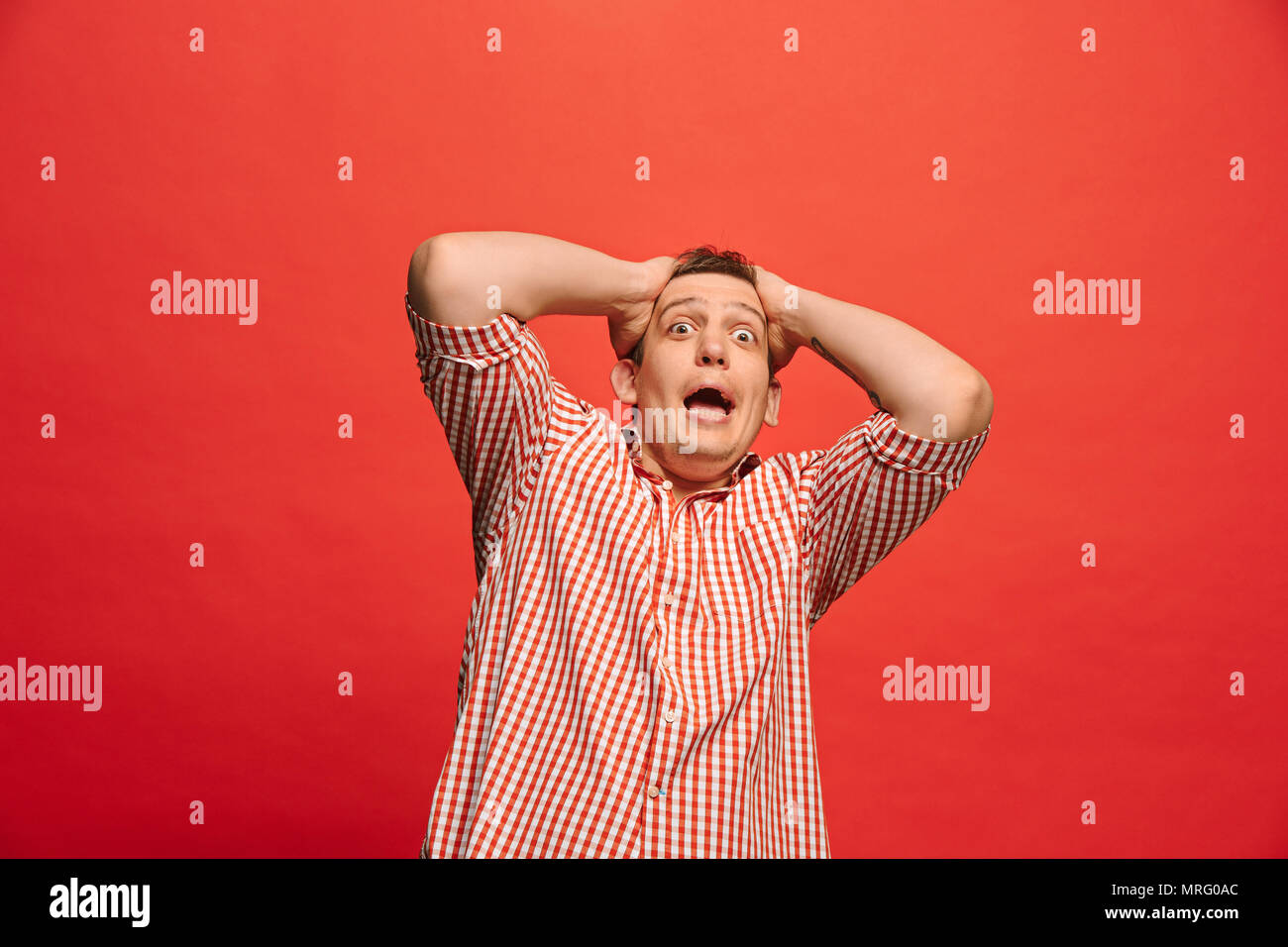 Portrait of the scared man on red Stock Photo - Alamy