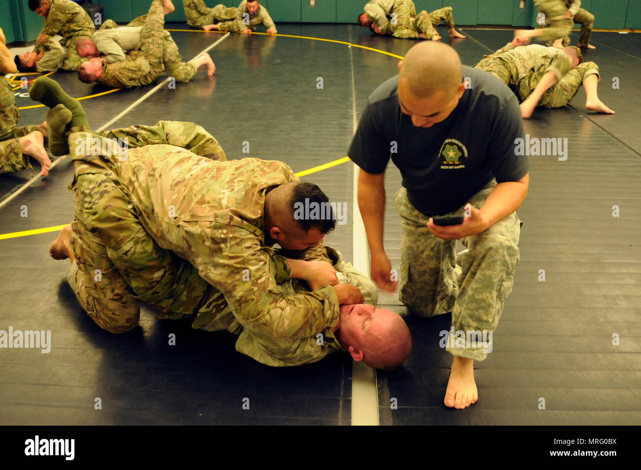 Staff Sgt. Baugh, in instructor for the course, coaches the Soldiers ...