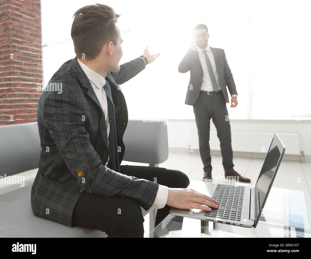businessman with laptop pointing at the screen Stock Photo - Alamy