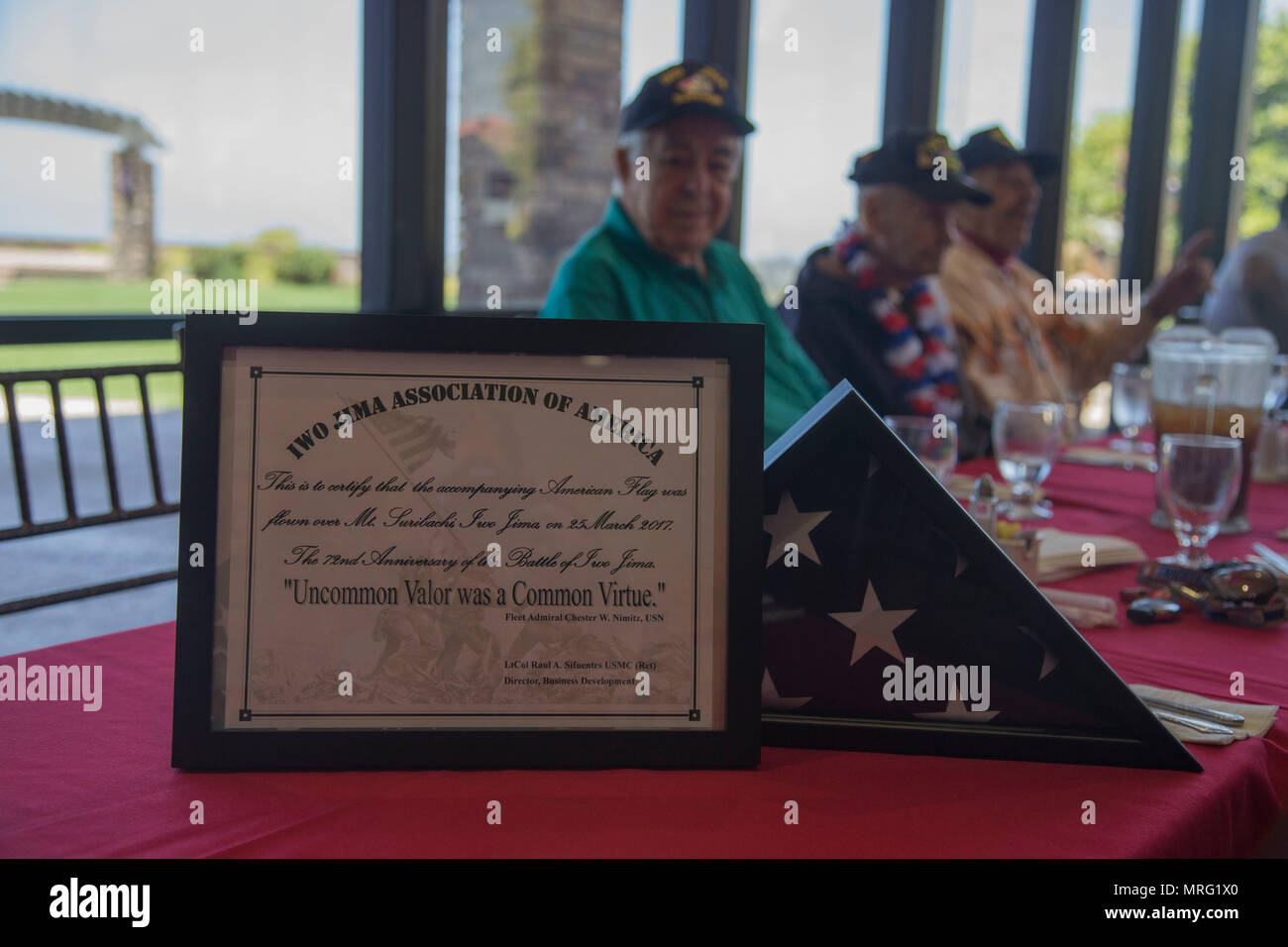 An American flag with 48 stars and a certificate certifying that the ...