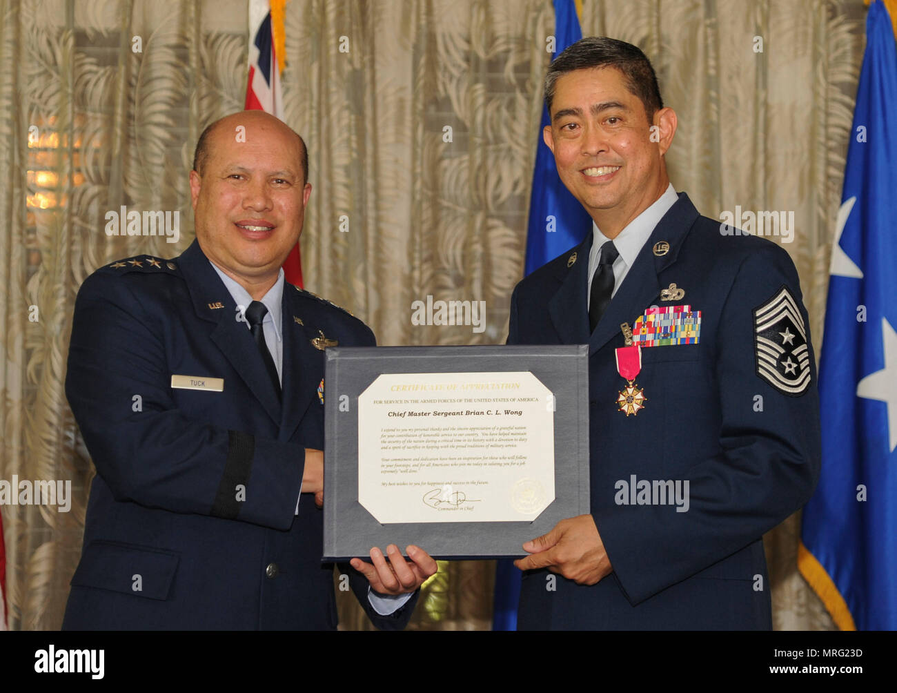 Lt. Gen. Giovanni Tuck, Eighteenth Air Force commander, presents a ...