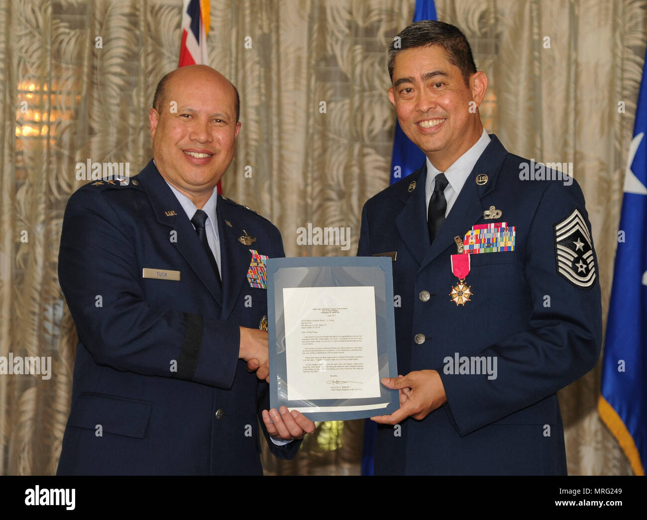 Lt. Gen. Giovanni Tuck, Eighteenth Air Force commander, presents a ...