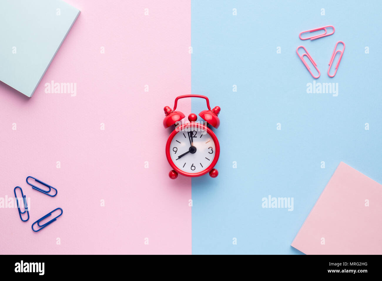 Flat lay on a pastel pink and blue background with a Notepad paperclip ...