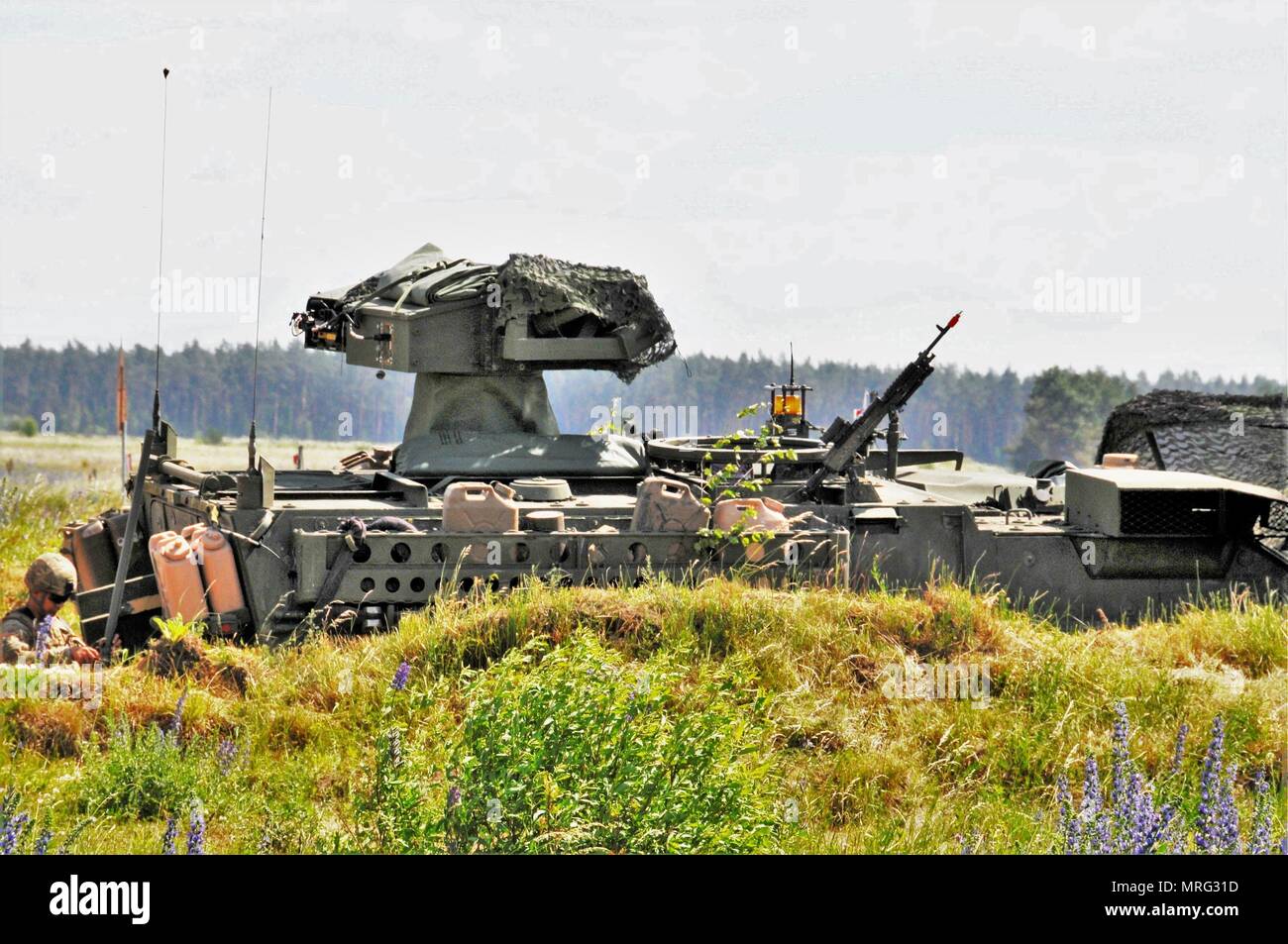 Battle Group Poland U.S. Soldiers sit in an overwatch position near the ...
