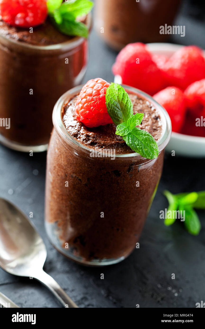 Glass of homemade dark chocolate mousse with raspberries Stock Photo ...