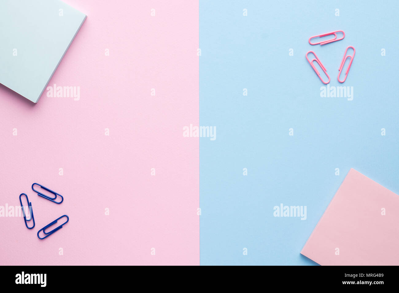 Flat lay on a pastel pink and blue background with a Notepad paperclip ...