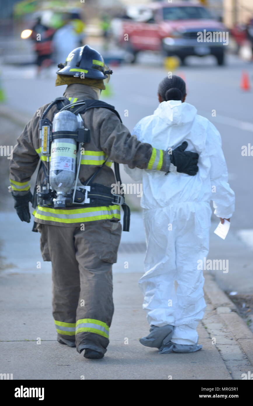 A member of the Canton Fire Department escorts a simulated casualty ...