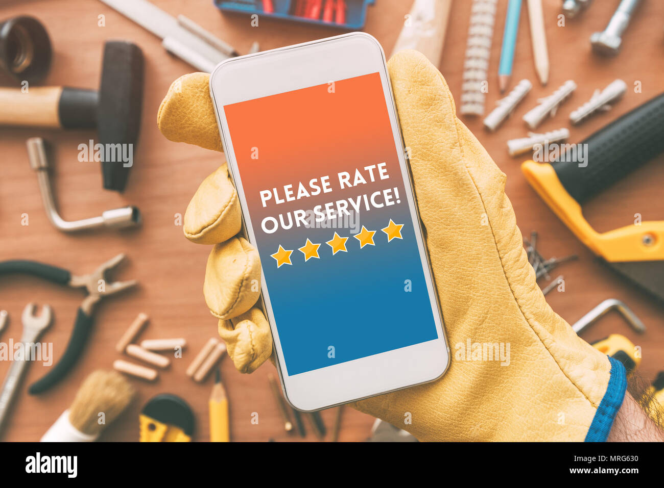 Please rate our service message on smartphone screen in male hand ...