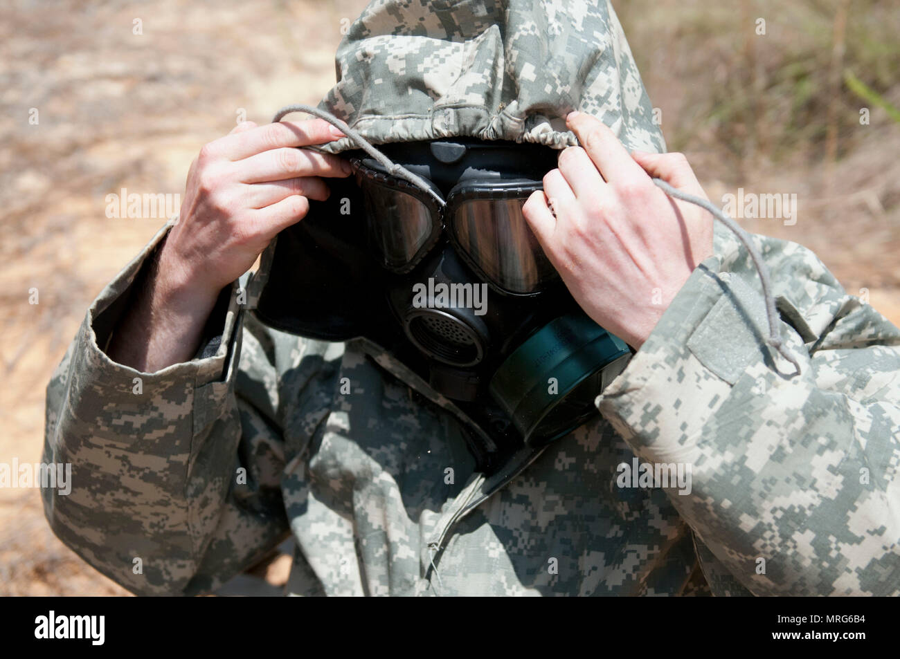 A Warrior dons his gear during a nuclear, biological, chemical attack ...