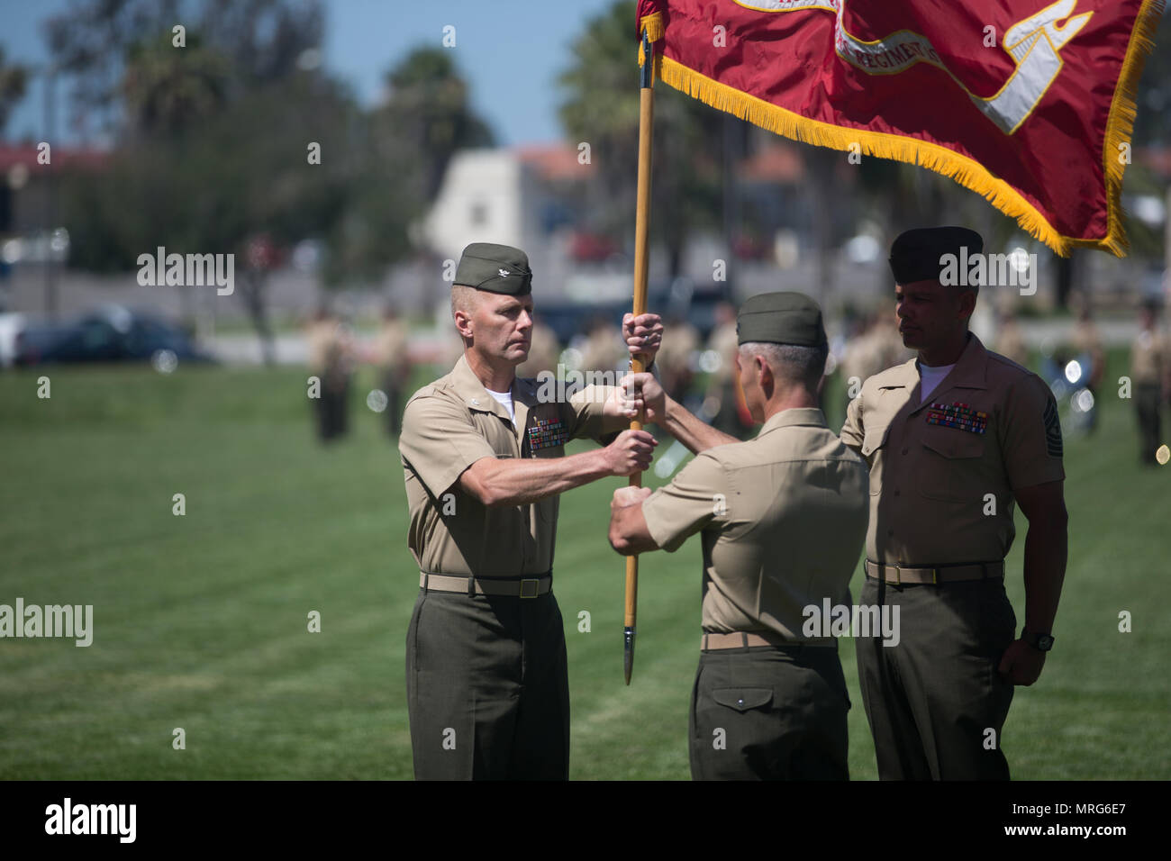 U.S. Marine Col. Phillip N. Frietze (center) exchanges the regimental ...