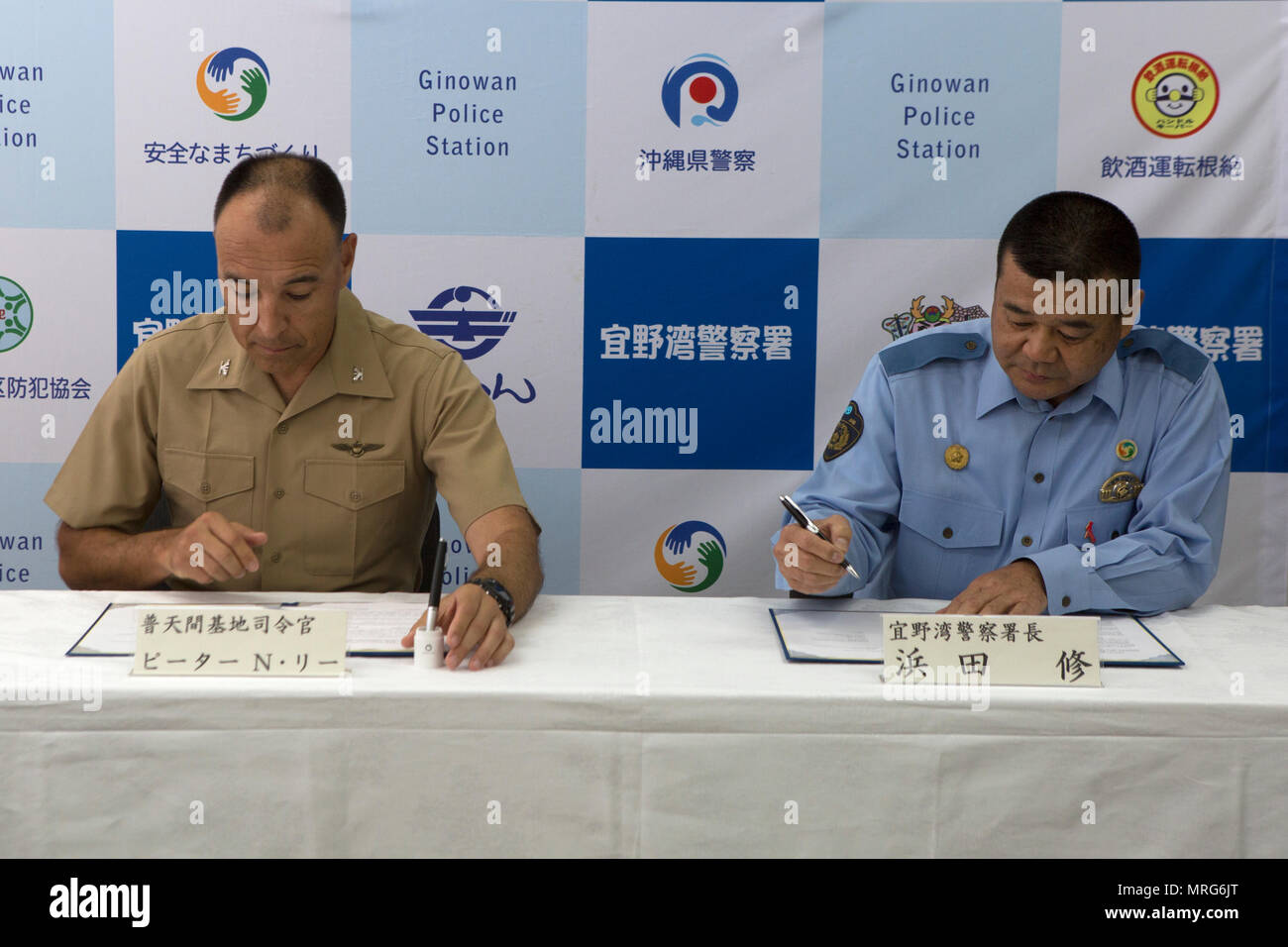 GINOWAN, OKINAWA, Japan— Col. Peter Lee, left, and Ginowan Police Chief ...
