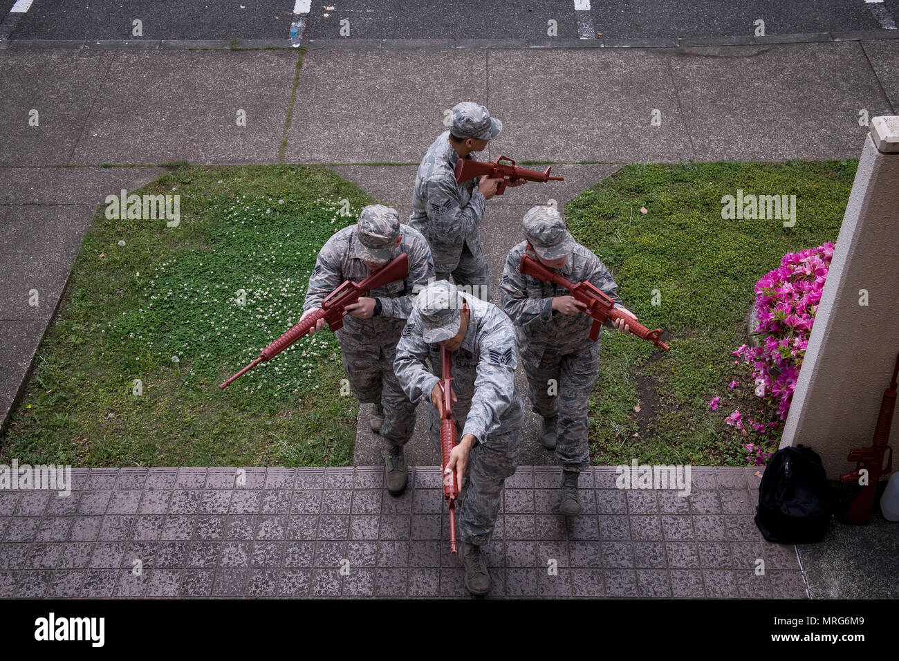 374th Security Forces Squadron members enter a building in formation ...
