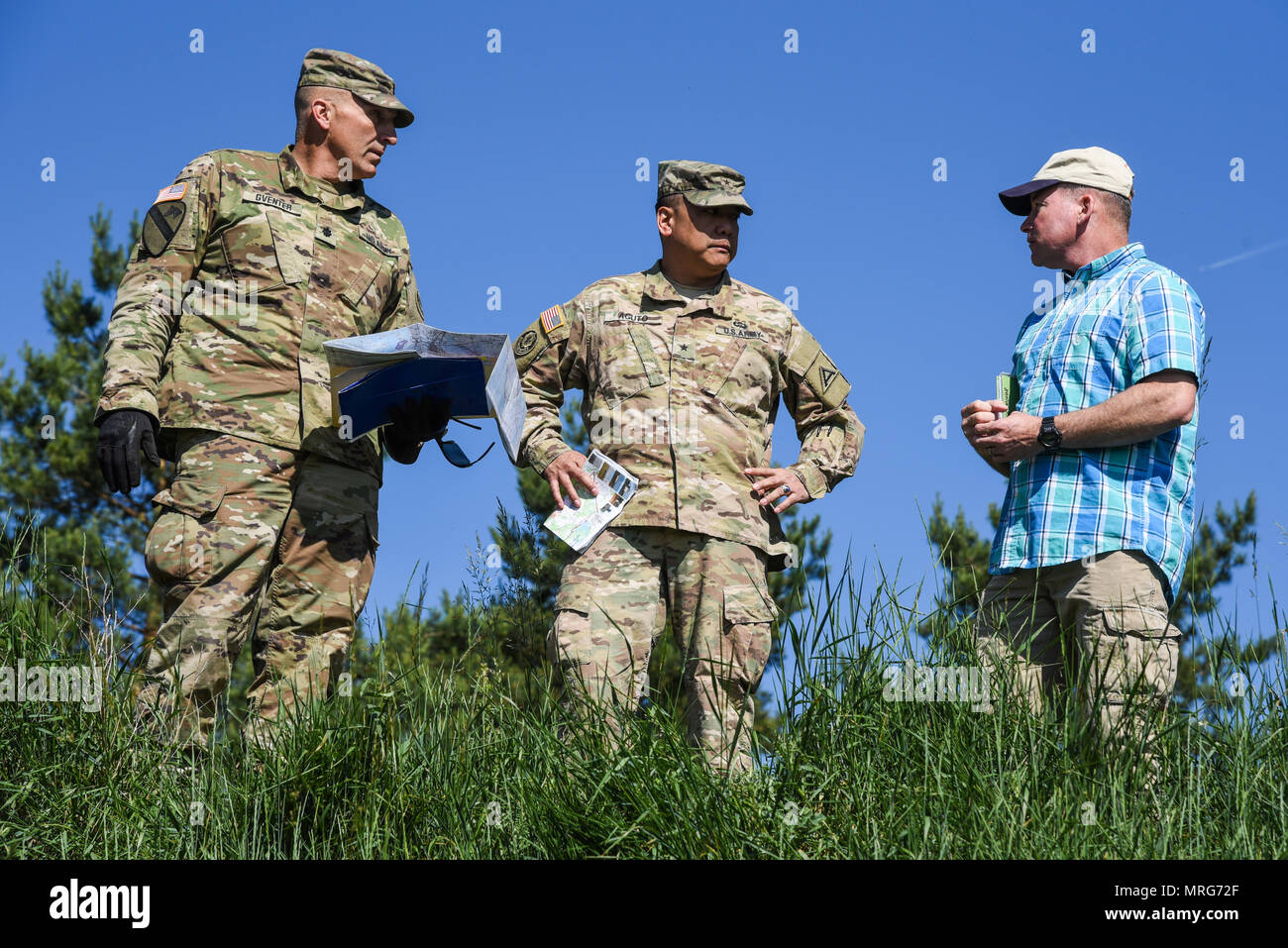 U.S. Army Brig. Gen. Tony Aguto, center, Commanding General of 7th Army ...