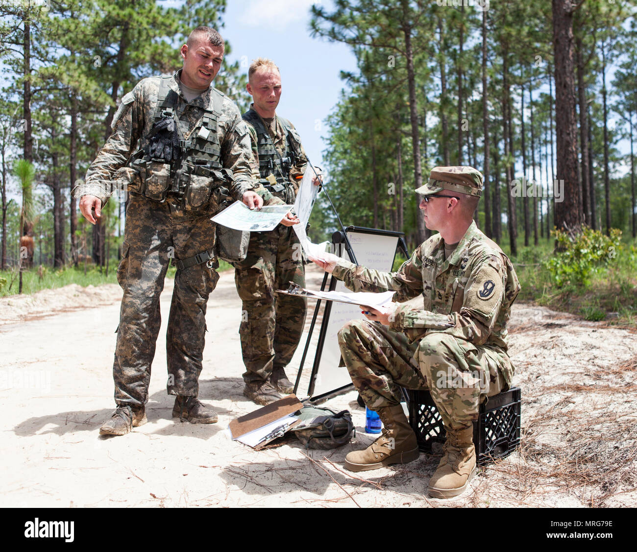Sgt. Benjamin Poulin, 824th Transportation Company, (left), hands his ...