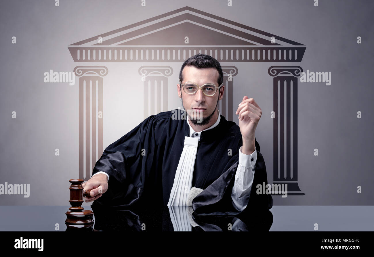 Young judge in front of a courthouse symbol making decision Stock Photo ...