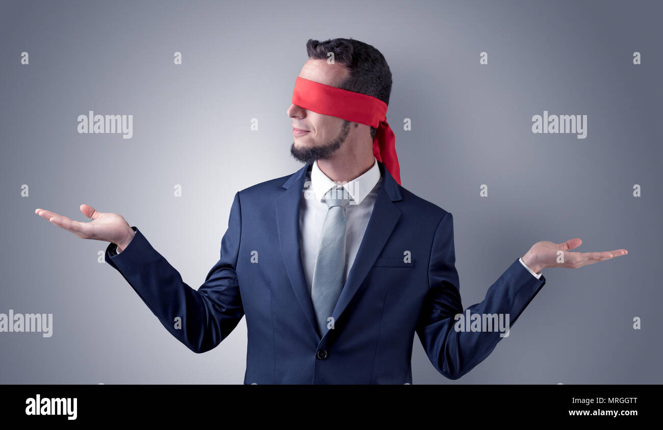 Covered eye, indecisive businessman standing blind in front of a wall ...