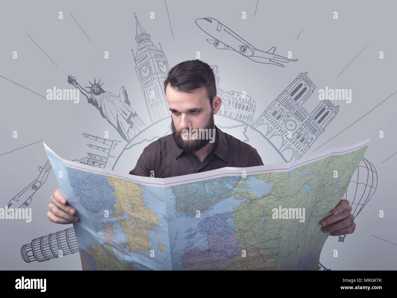Handsome young man holding a map with famous sightseeing destinations ...
