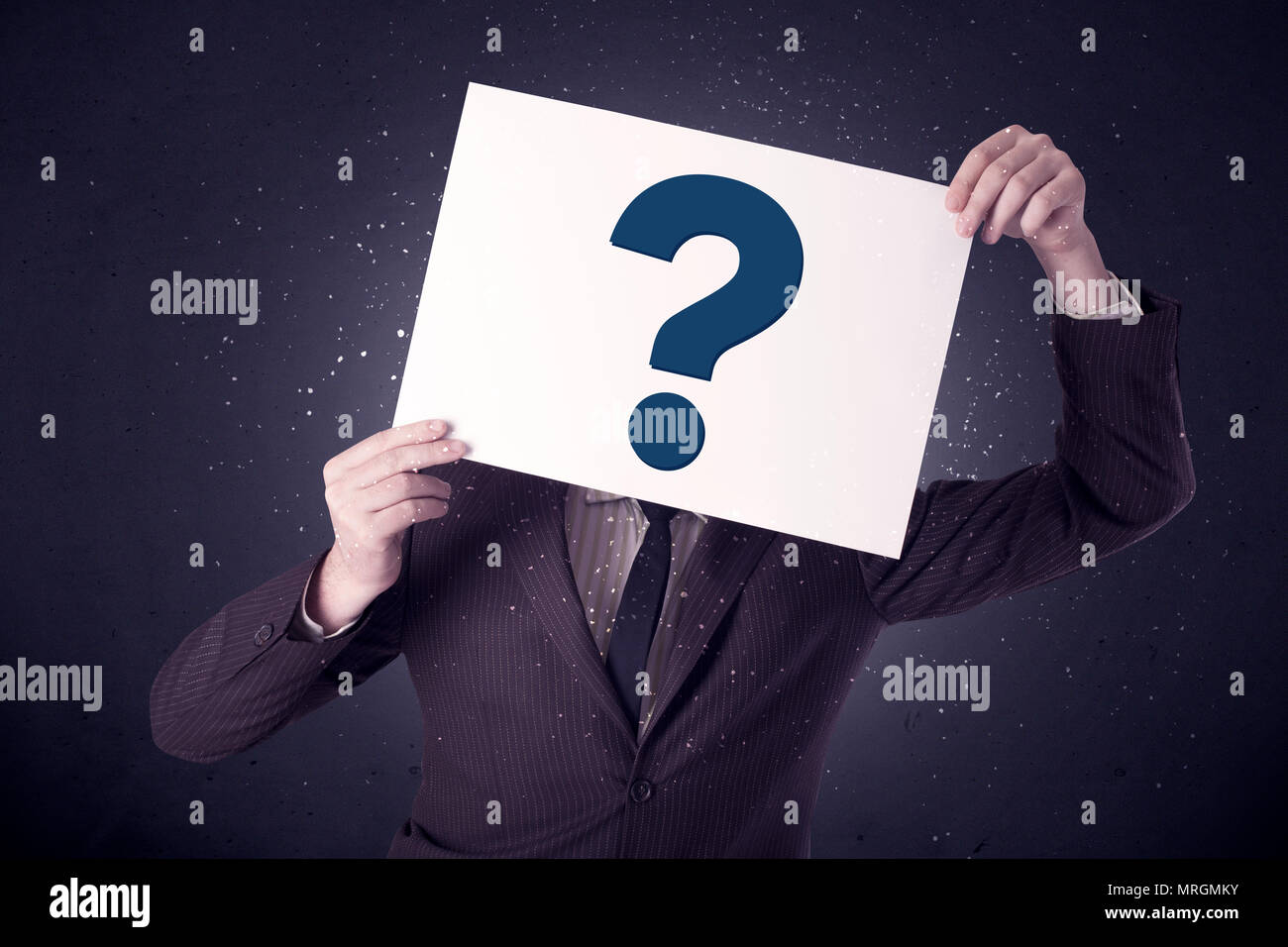 Young businessman hiding behind a question mark drawn on paper Stock ...