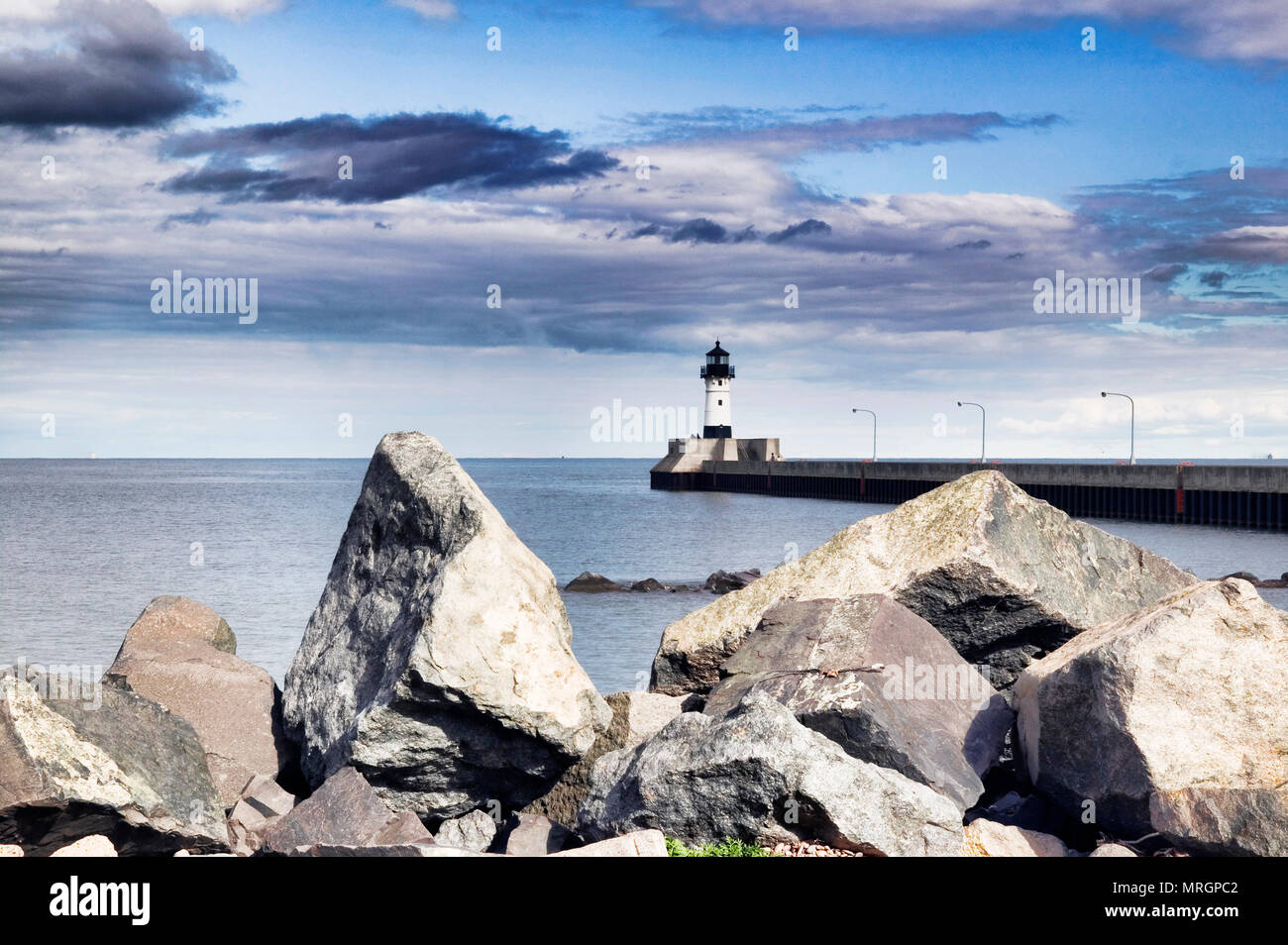A lighthouse marks the entry of the Duluth harbor and lift bridge ...