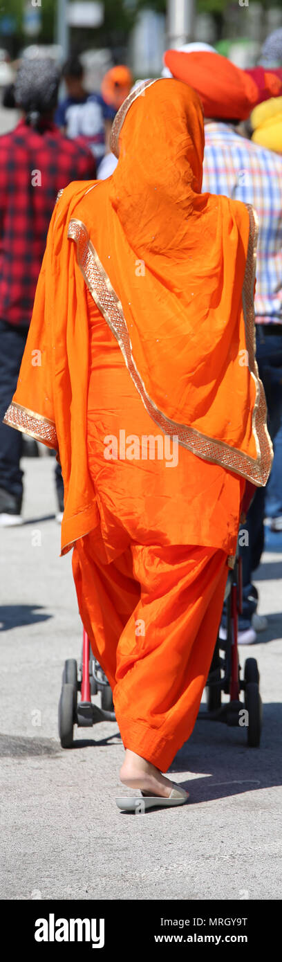 sikh young mother walks with stroller and orange dress Stock Photo - Alamy