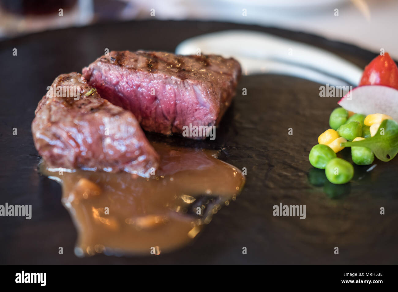 Medium rare meat on plate with sauce Stock Photo - Alamy