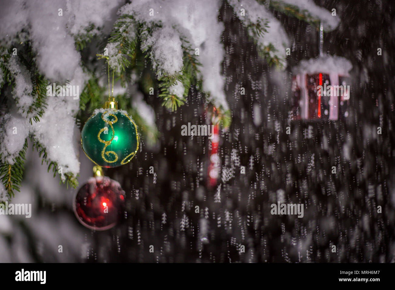 Christmas decorations on a fir tree, with snowflakes, mild light, gifts ...
