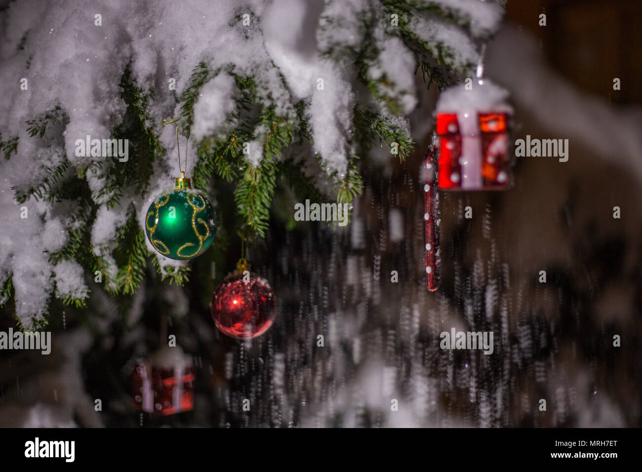 Christmas decorations on a fir tree, with snowflakes, mild light, gifts ...