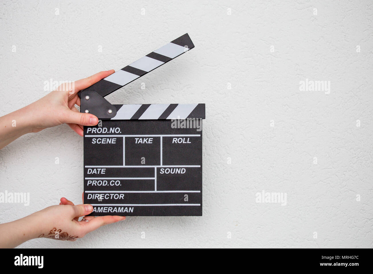 Female hands holding movie clapper isolated on white Stock Photo - Alamy