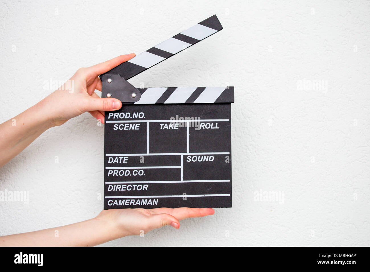 Hand holding film clap board hi-res stock photography and images - Alamy