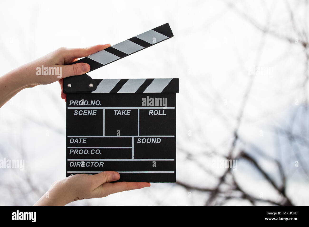 Female hands holding movie clapper isolated on white Stock Photo - Alamy