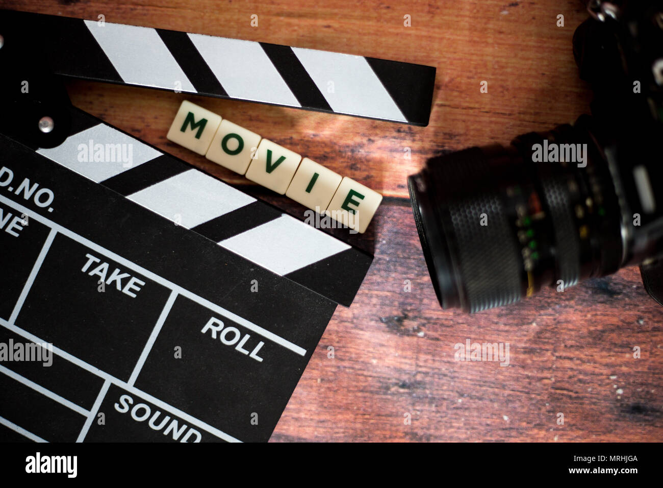 Movie clapper and old camera on a wooden background, movie shooting ...