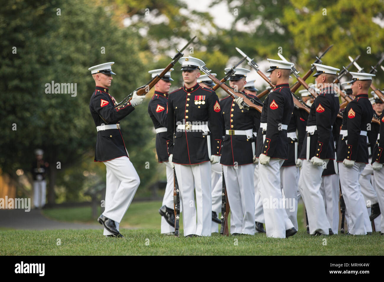 The U.S. Marine Corps Silent Drill Platoon performs during a sunset ...