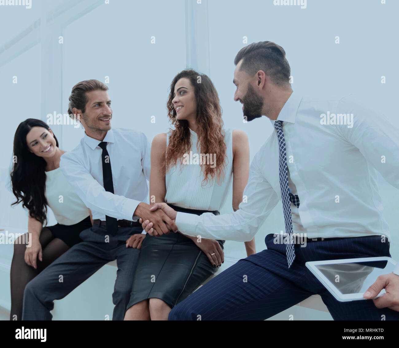 welcome handshake between two colleagues Stock Photo - Alamy