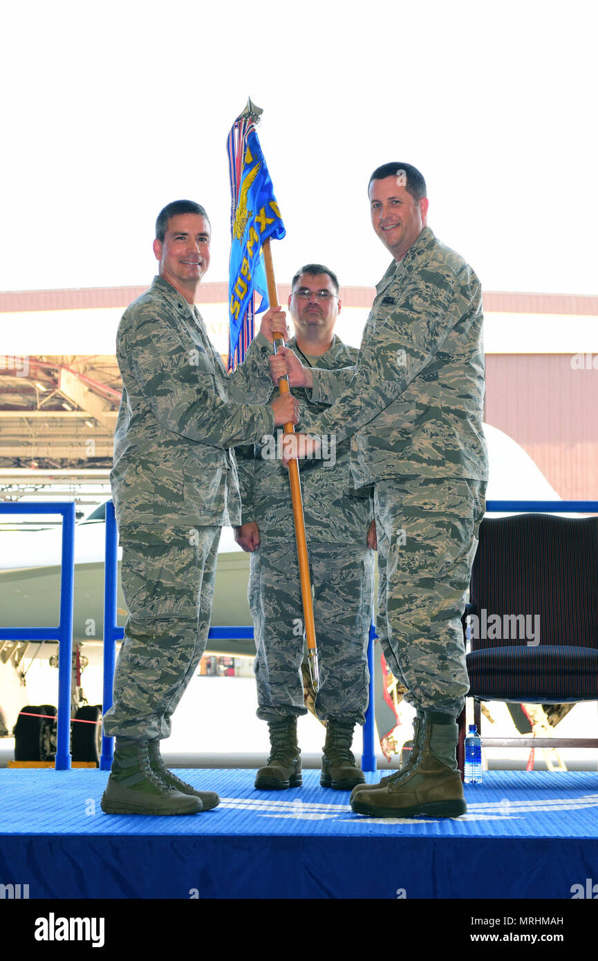 U.S. Air Force Col. Mark Riselli, the 509th Maintenance Group (MXG) commander, right, receives ...