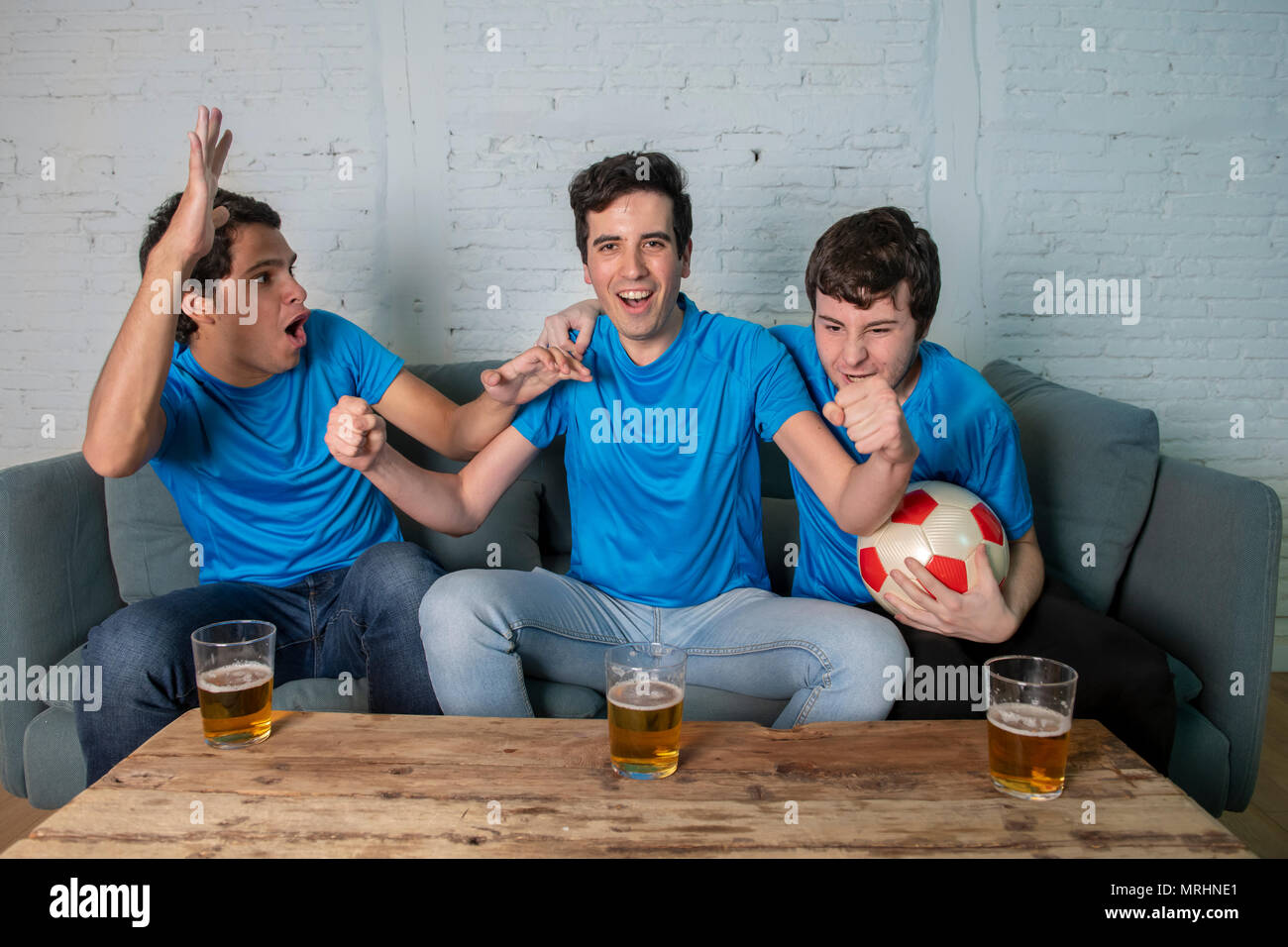 Watching football on sofa hi-res stock photography and images - Alamy