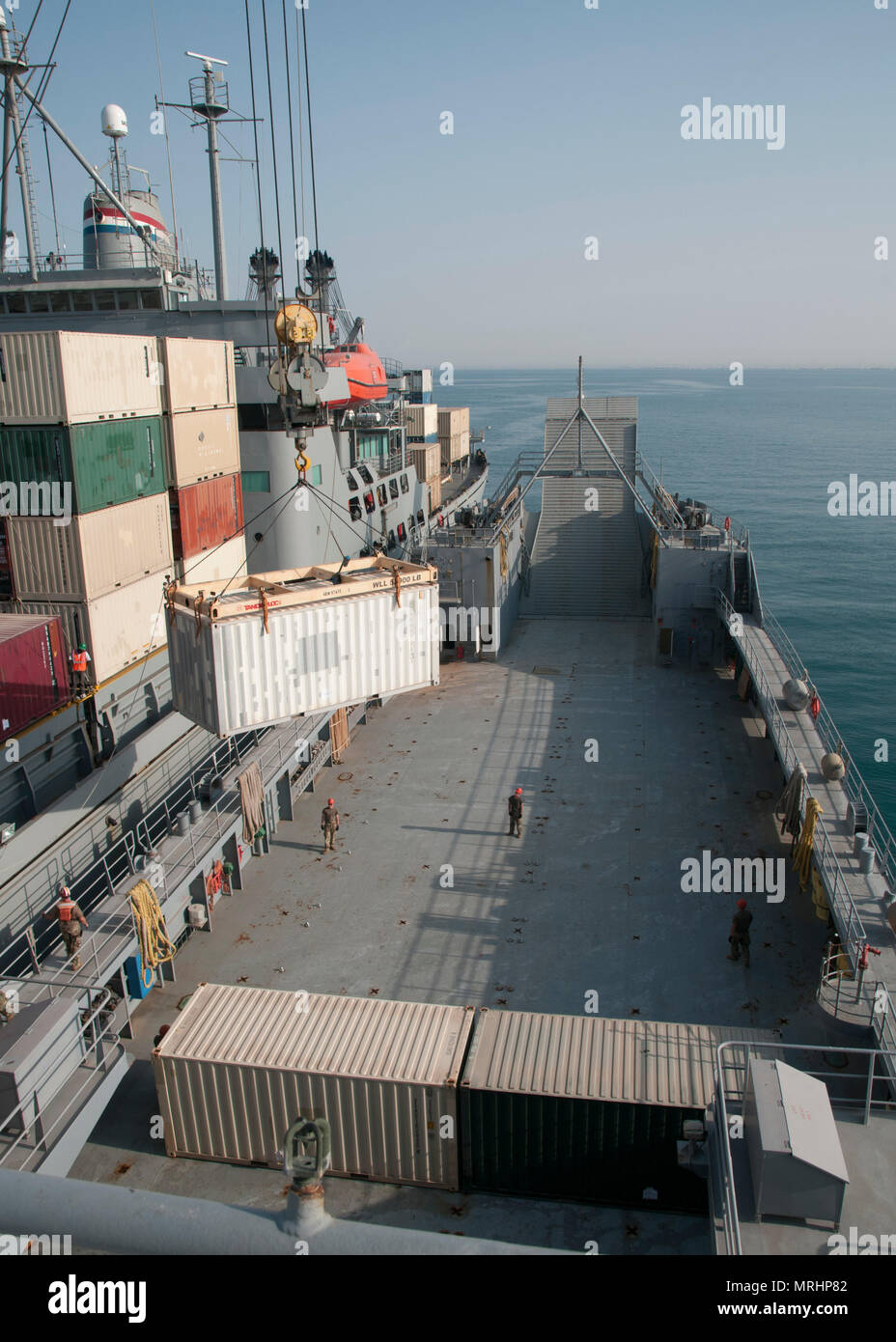 The Military Sealift Command Vessel Gem State transfers a container to ...