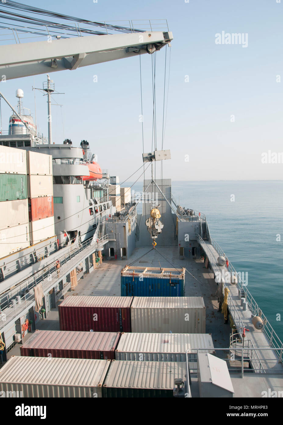 The Military Sealift Command Vessel Gem State transfers a container to ...