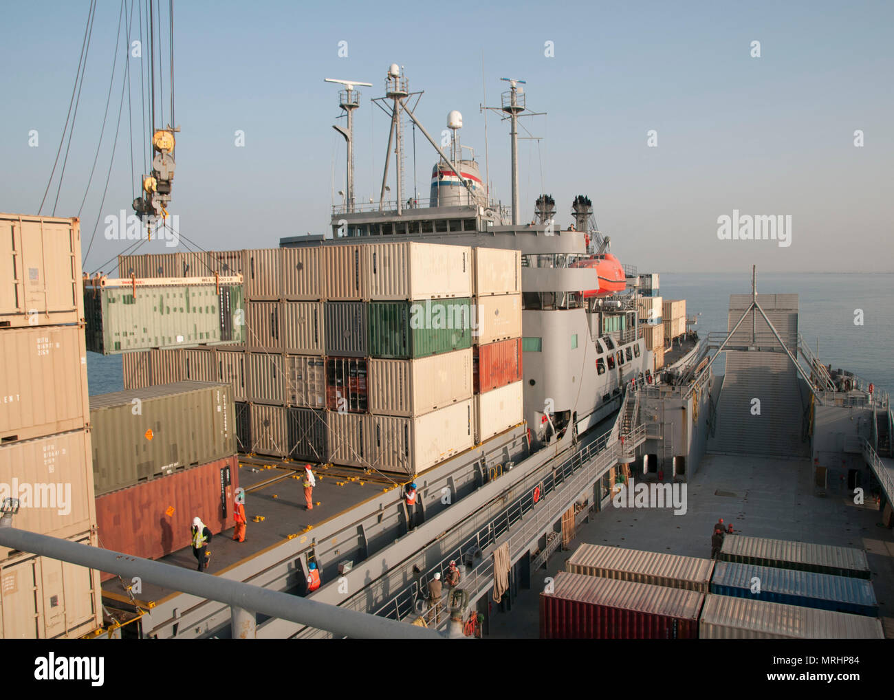 The Military Sealift Command Vessel Gem State transfers a container to ...